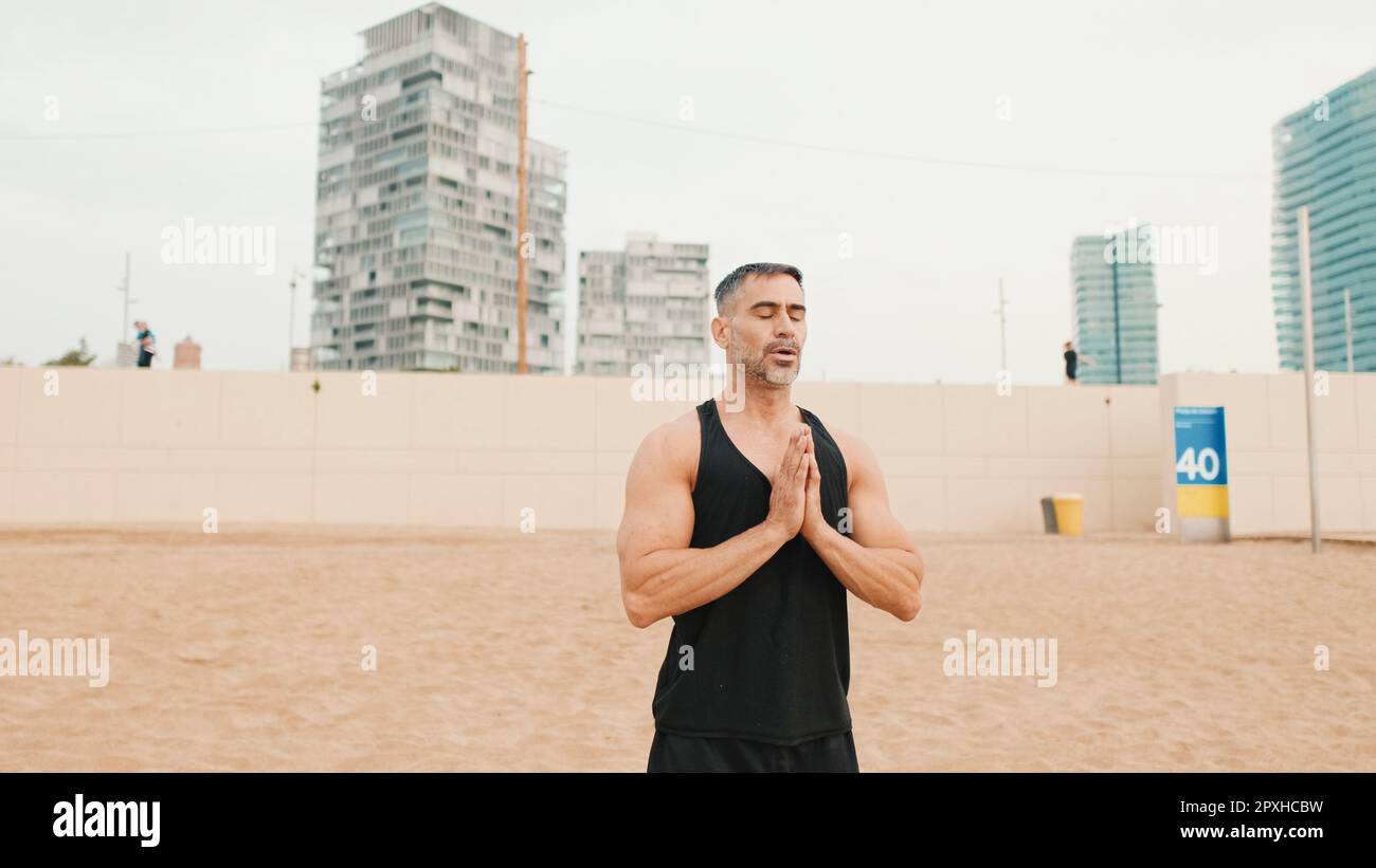 Close-up, middle-aged man doing relaxing breathing exercises standing ...