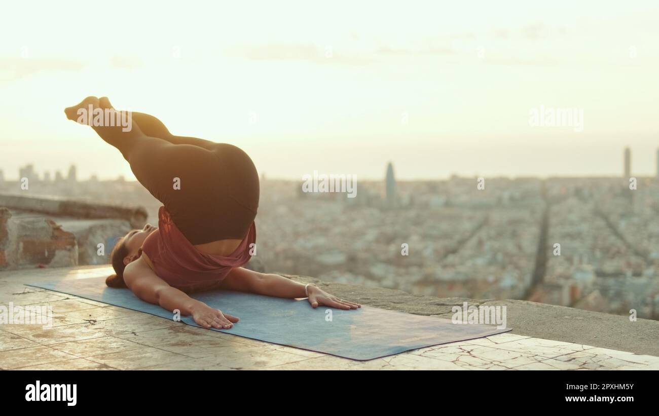 Woman making bridge pose practicing yoga Stock Photo - Alamy