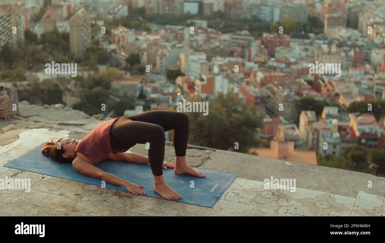 Woman making bridge pose practicing yoga Stock Photo - Alamy