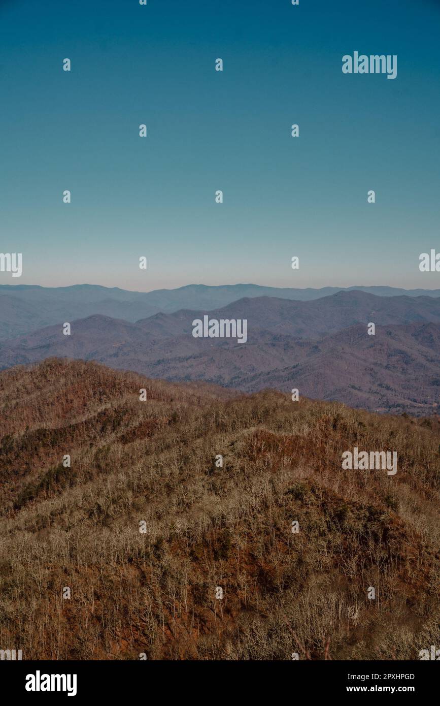 Aerial view of a hill overlooking the majestic mountains in the fall ...