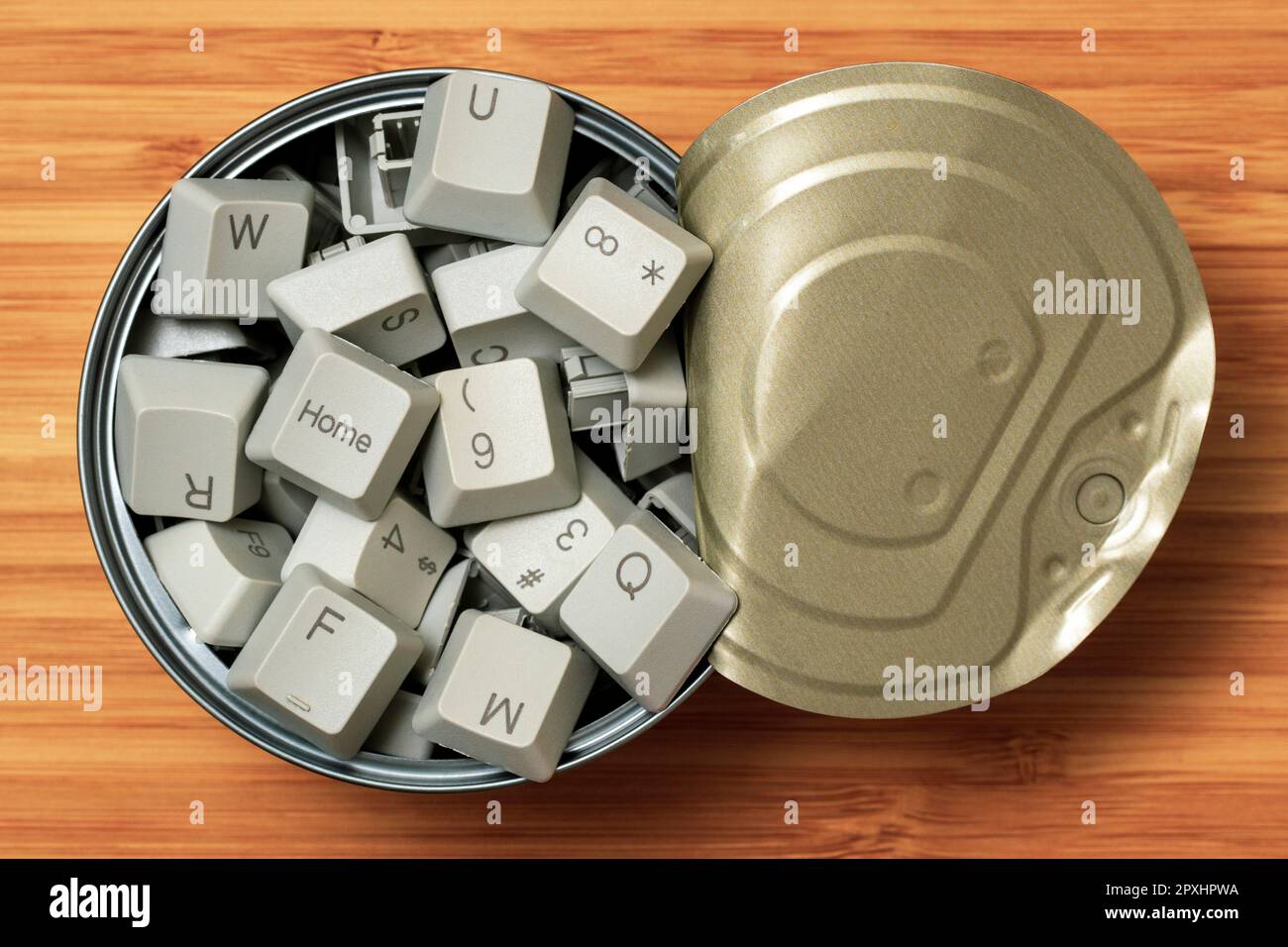 Opened tin can full of computer keyboard keys. Conceptual image Stock ...