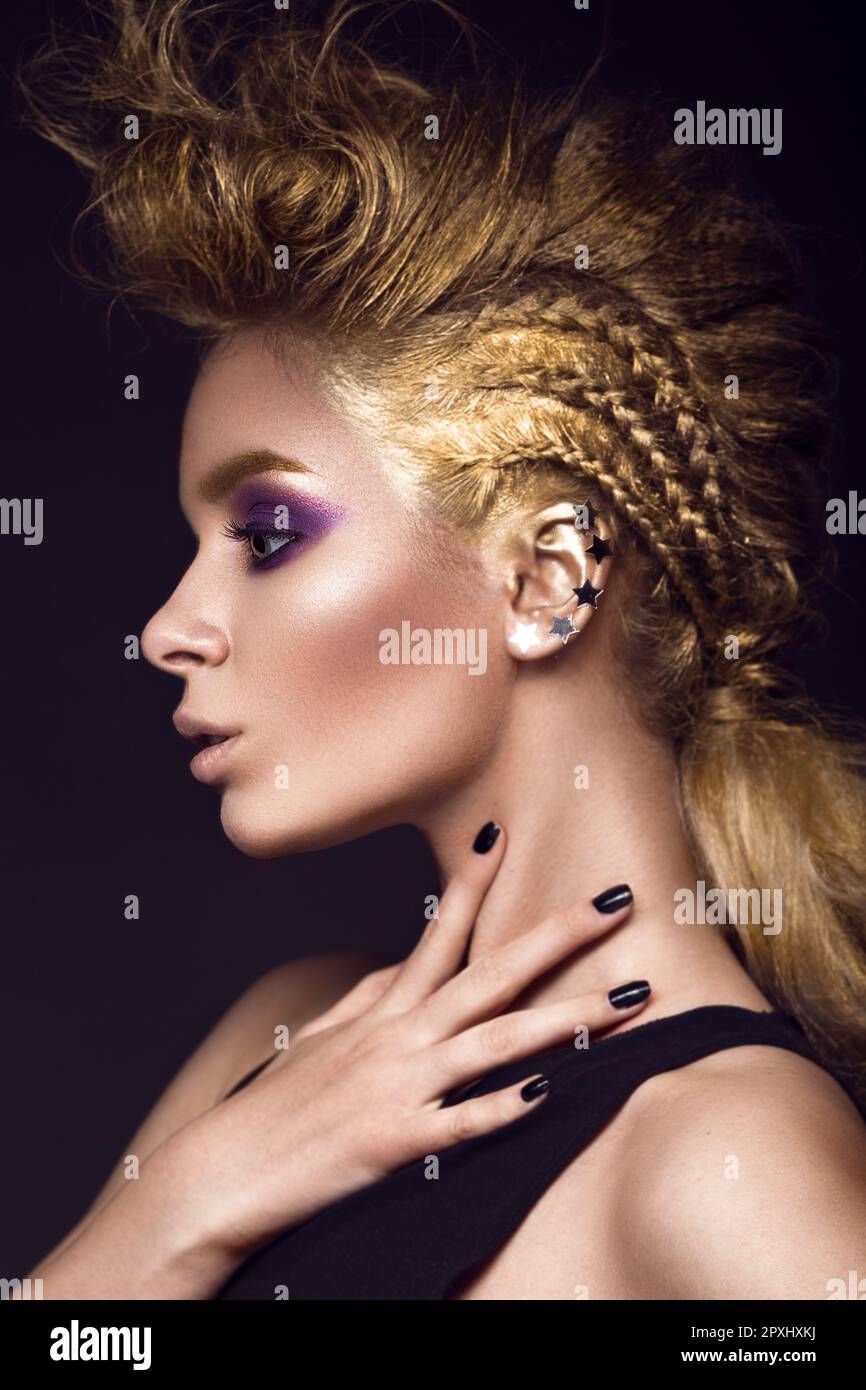 Daring girl with a mohawk hairstyle, painted in gold, punk style ...