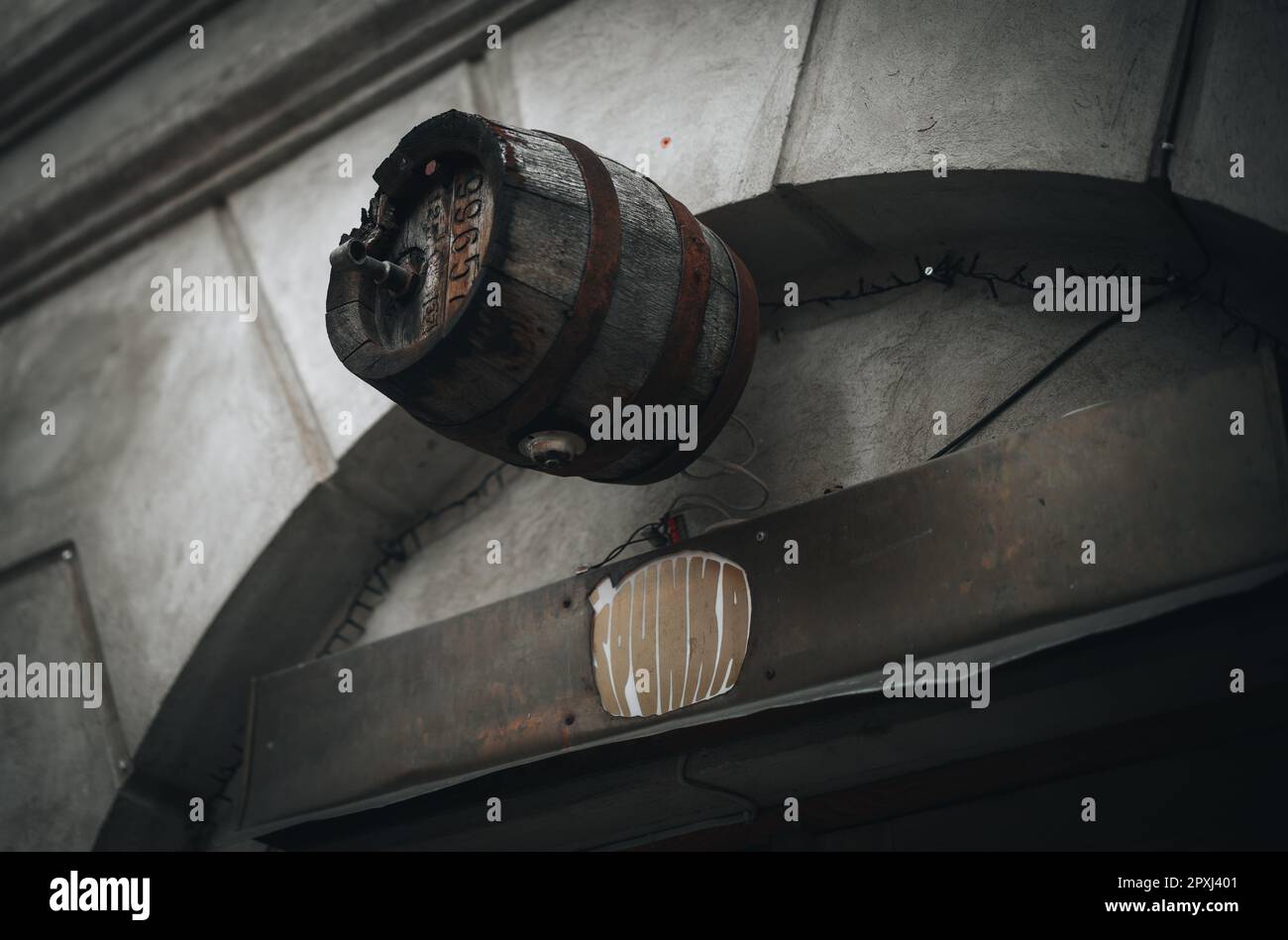 An empty beer barrel suspended from a wall in a building interior Stock ...