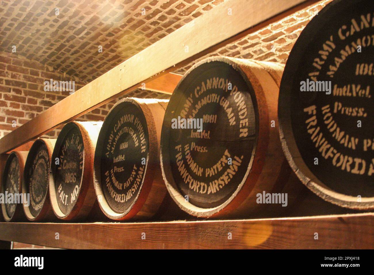 An array of wooden military cannonpowder barrels are neatly placed side ...