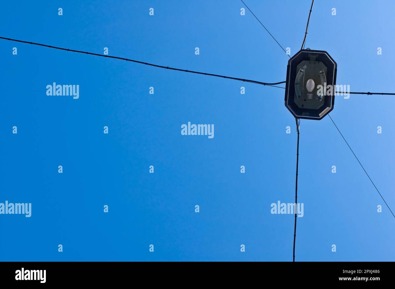 A street light and multiple electrical power lines extending into the ...