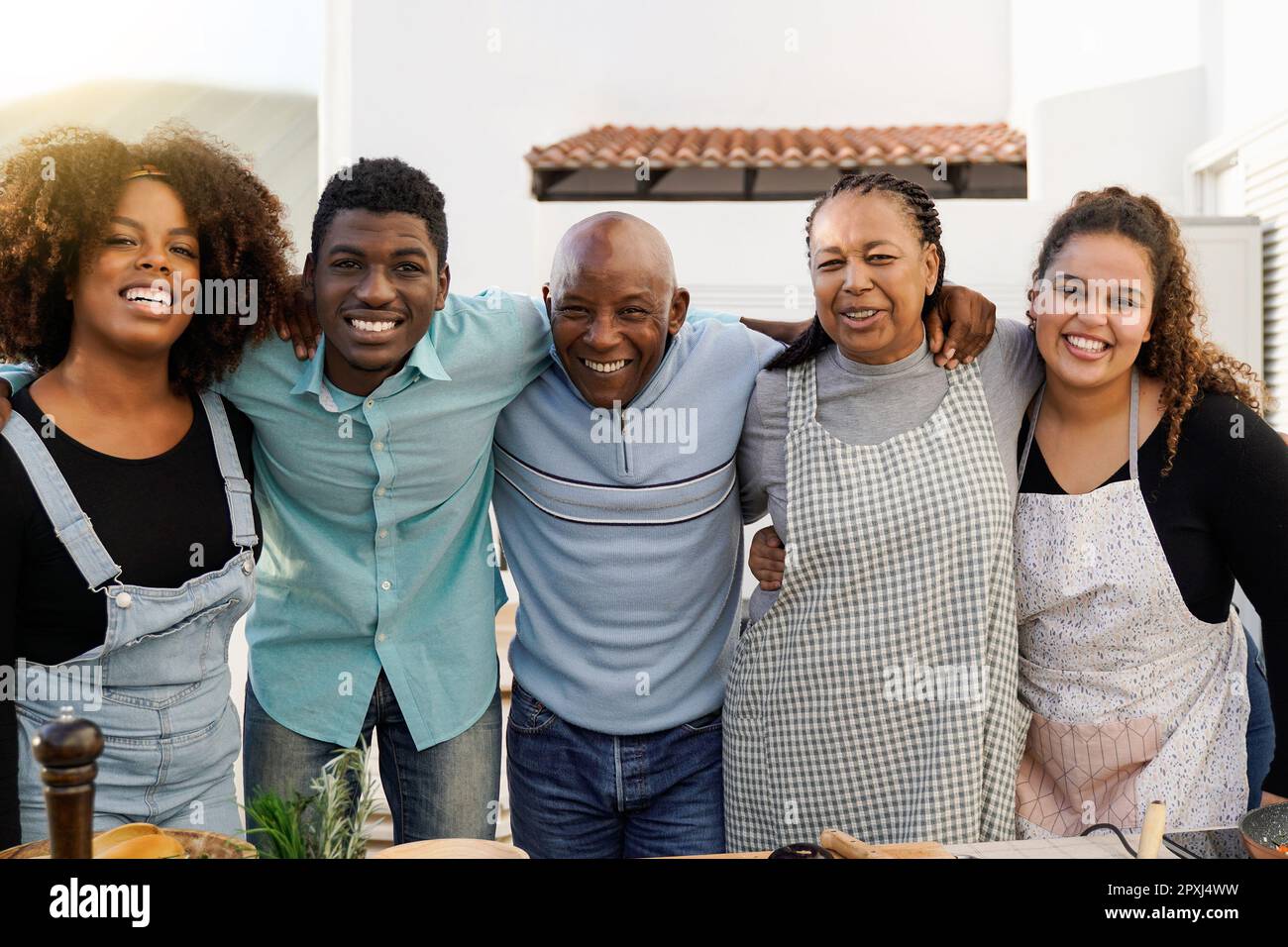 Kitchen outdoor: African family cooking vegetarian food at home patio ...
