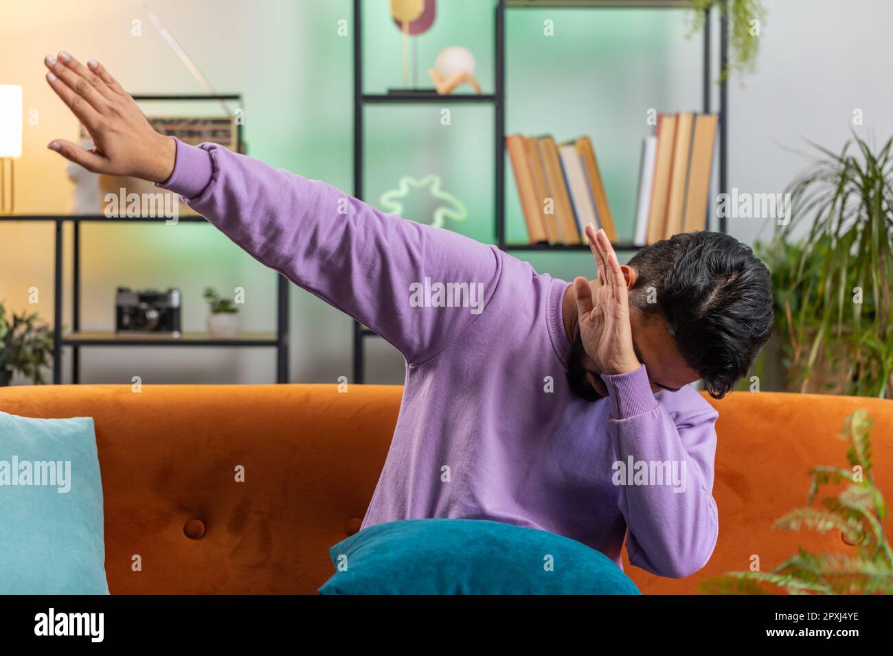 Trendy cheerful positive young indian man having fun dancing and moving ...