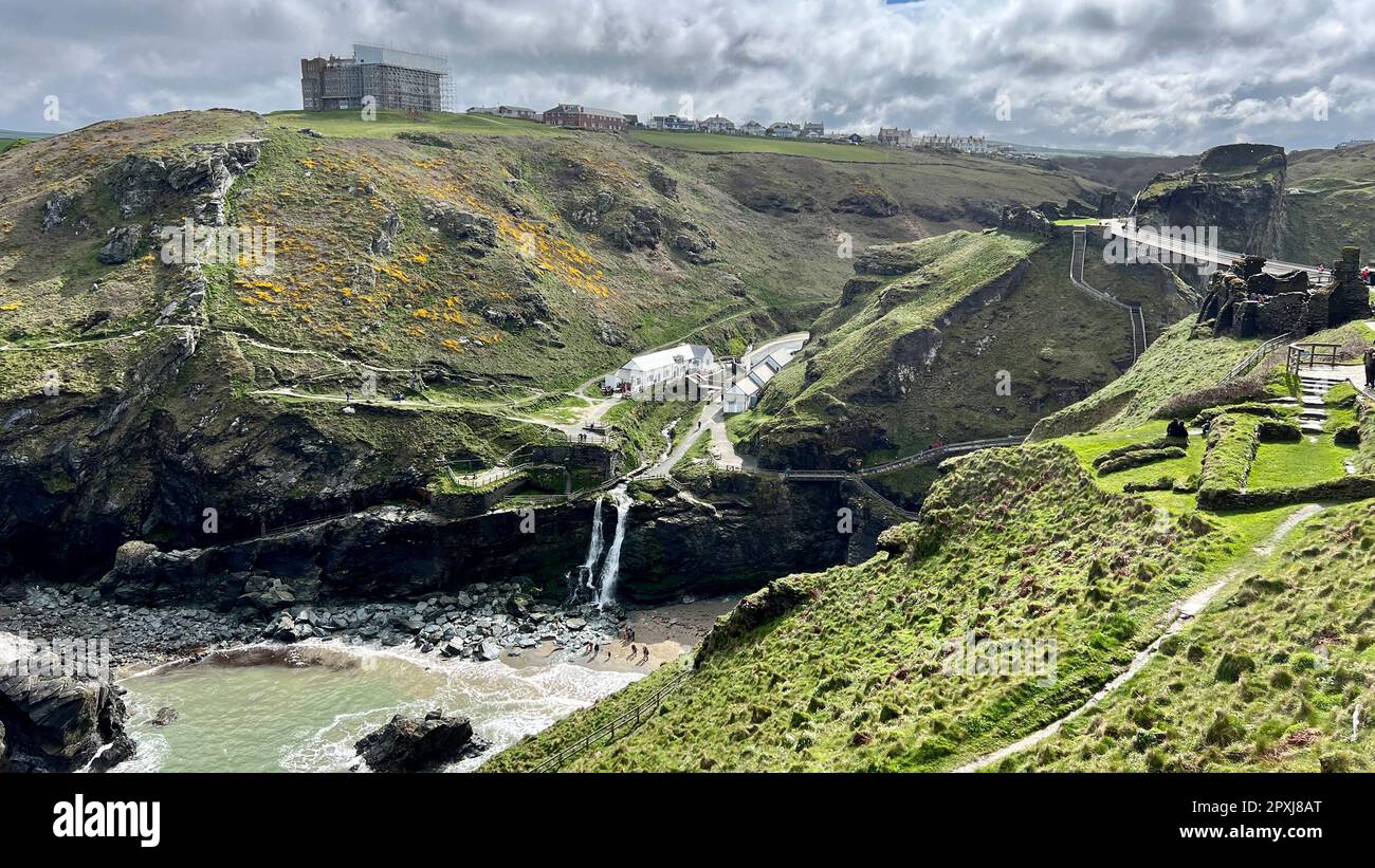 A serene view of a beach with clear blue ocean water and rocky ...