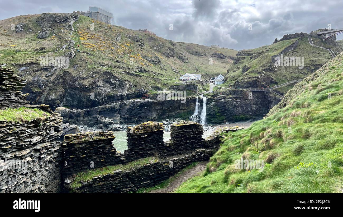 A serene view of a beach with clear blue ocean water and rocky ...