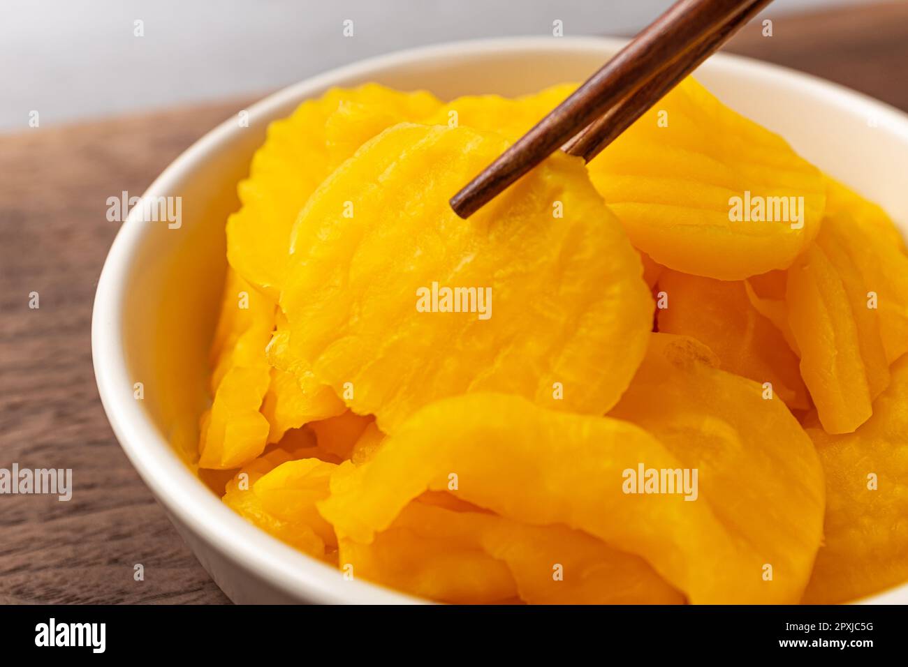 Chewy Pickled Radish Yellow with Gardenia Stock Photo - Alamy