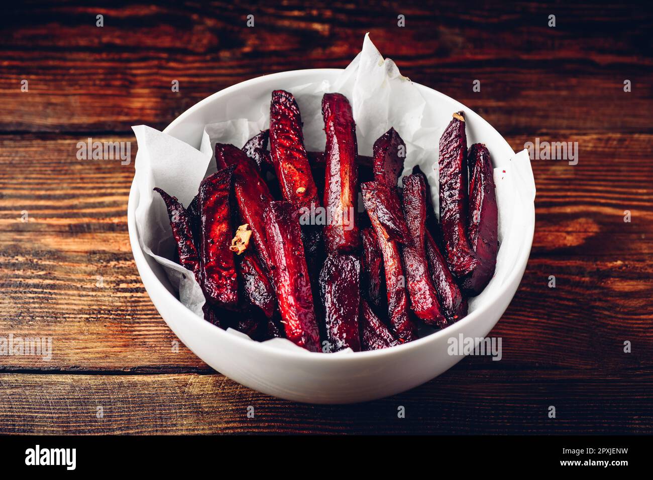 Oven baked beet fries in white bowl Stock Photo - Alamy
