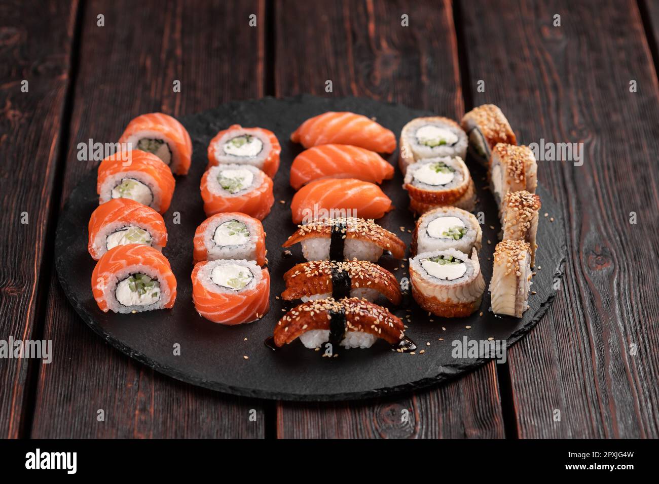 Large sushi set from top on black background. Assortment of various ...