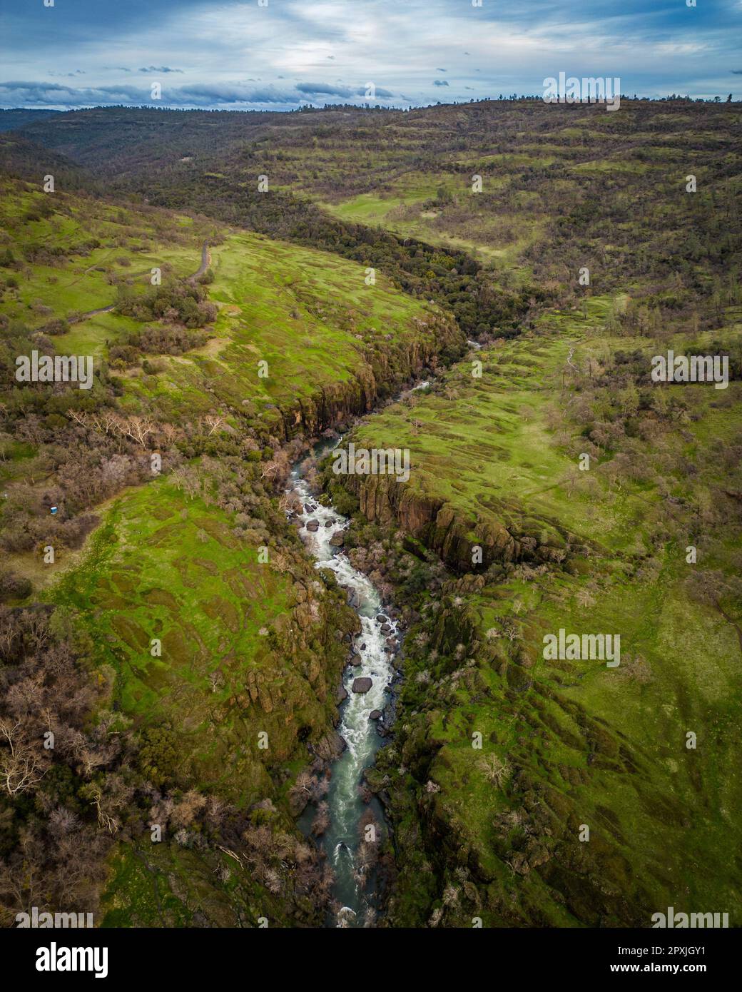 An aerial view of a fast-flowing river winding through a picturesque ...