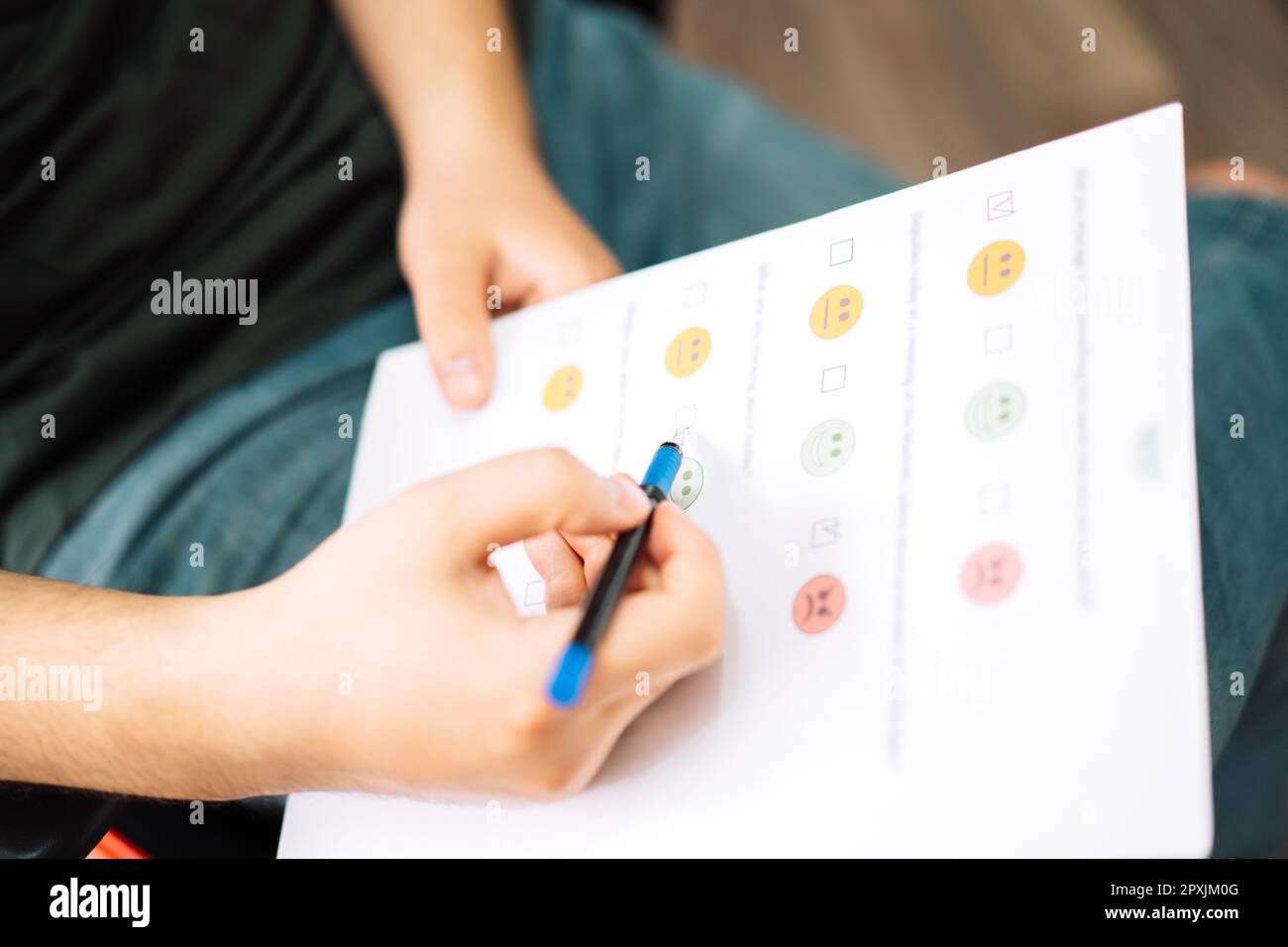 Man taking a psychological test with emoticons Stock Photo - Alamy