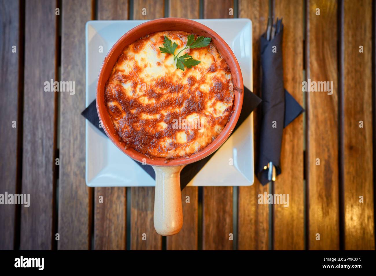 Close up shot of a freshly baked lasagna in a round pot Stock Photo - Alamy