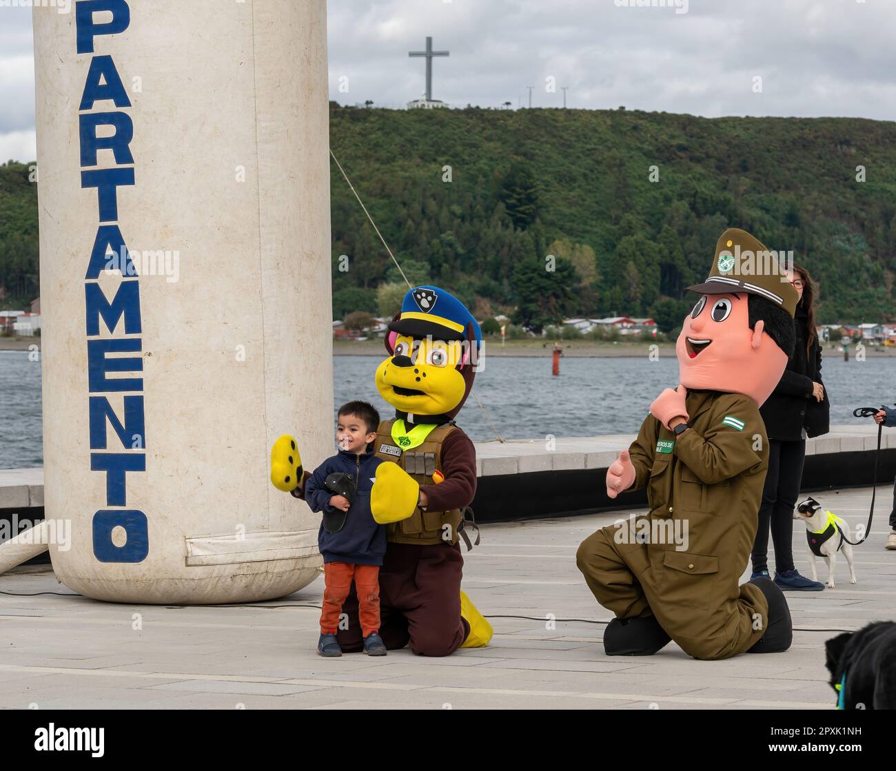 A child taking pictures with mascots dressed in military uniforms on ...