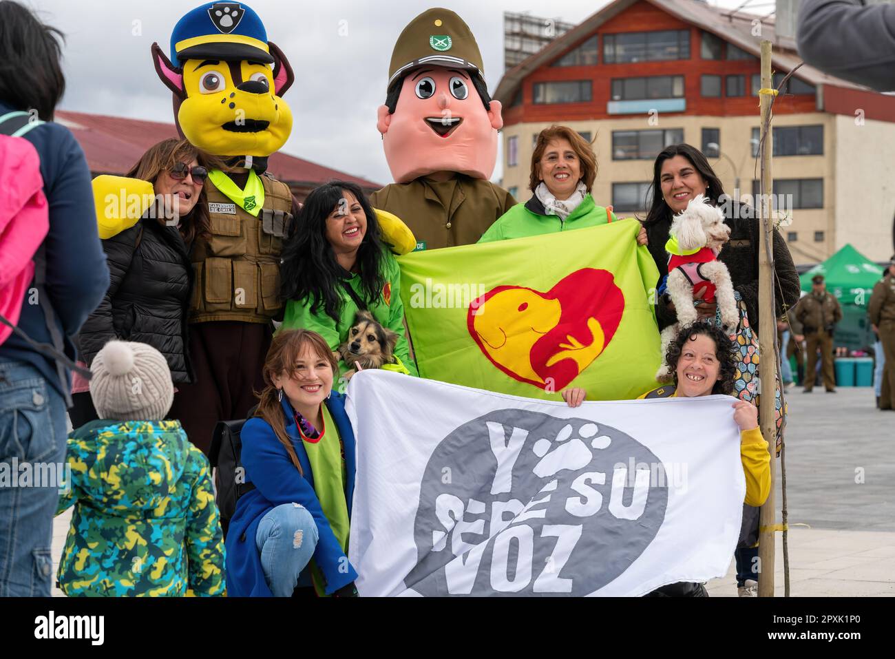 A people taking pictures with mascots dressed in military uniforms on ...