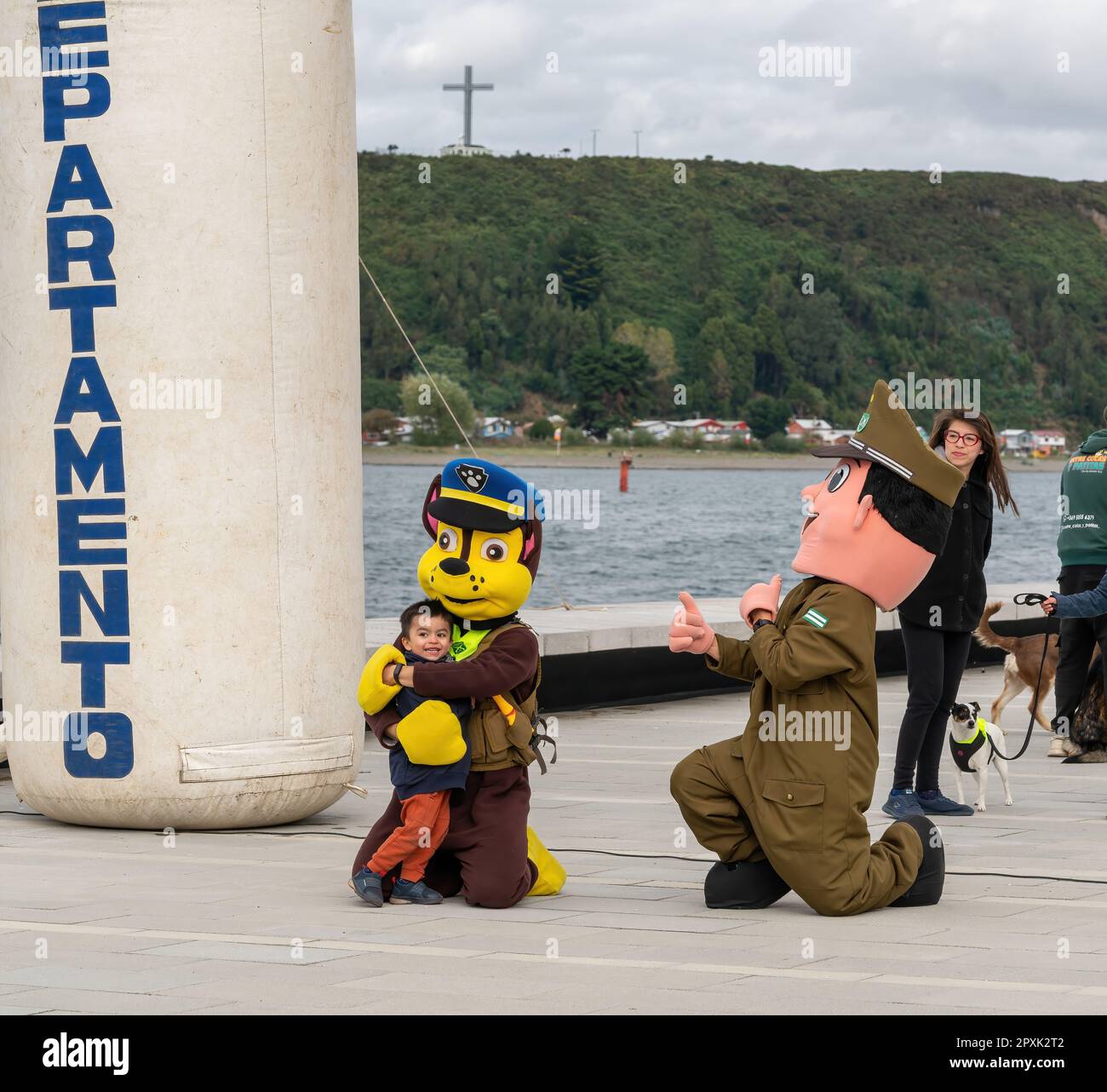 A child taking pictures with mascots dressed in military uniforms on ...