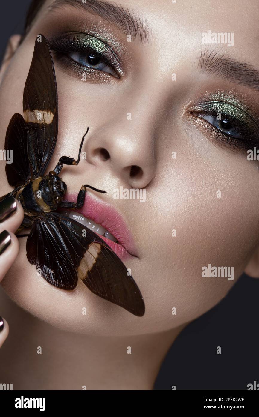 Portrait of beautiful girl with colorful make-up and cicada. Beauty ...
