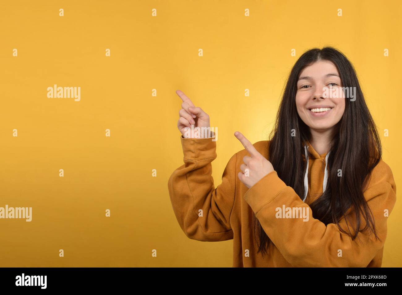 young pretty woman pointing direction with finger Stock Photo - Alamy