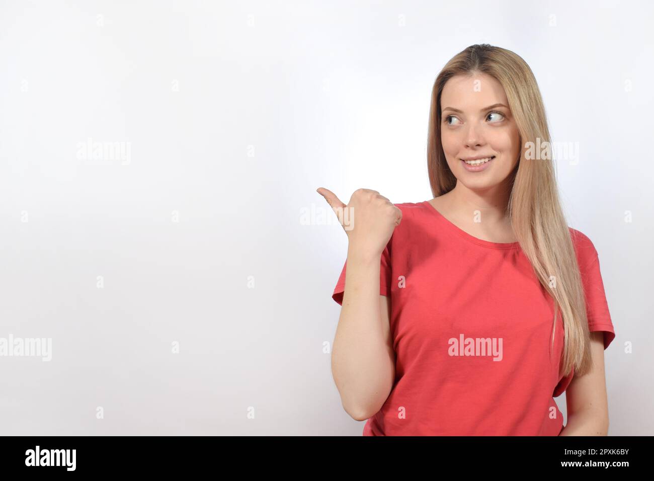young pretty woman pointing direction with finger Stock Photo - Alamy