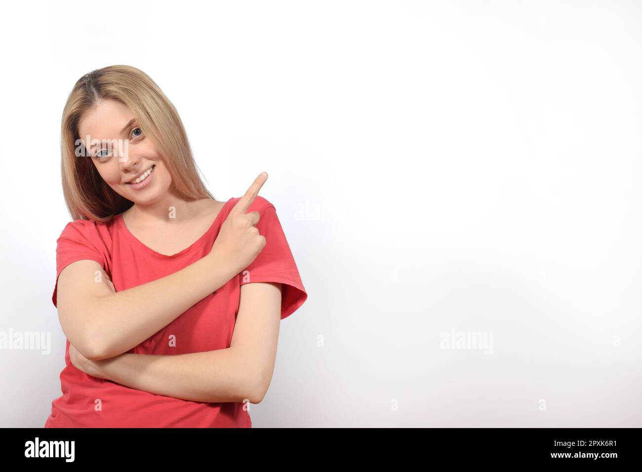 young pretty woman pointing direction with finger Stock Photo - Alamy