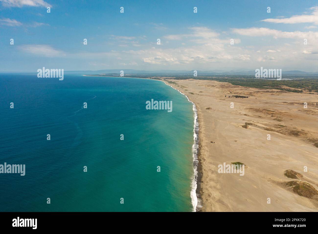 Top view of sandy beach and blue ocean. Paoay Sand Dunes, Ilocos Norte ...