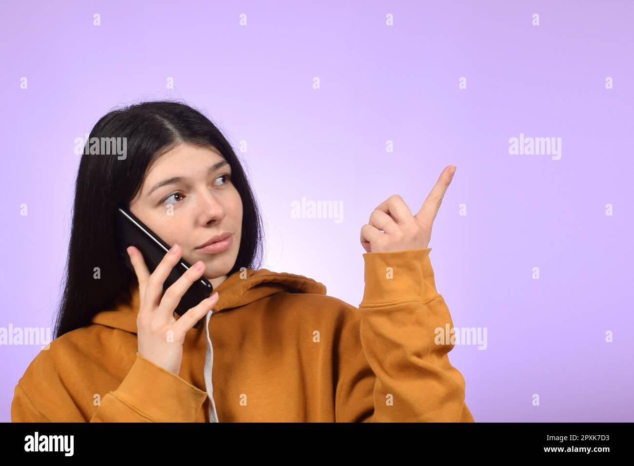 young pretty woman pointing direction with finger Stock Photo - Alamy