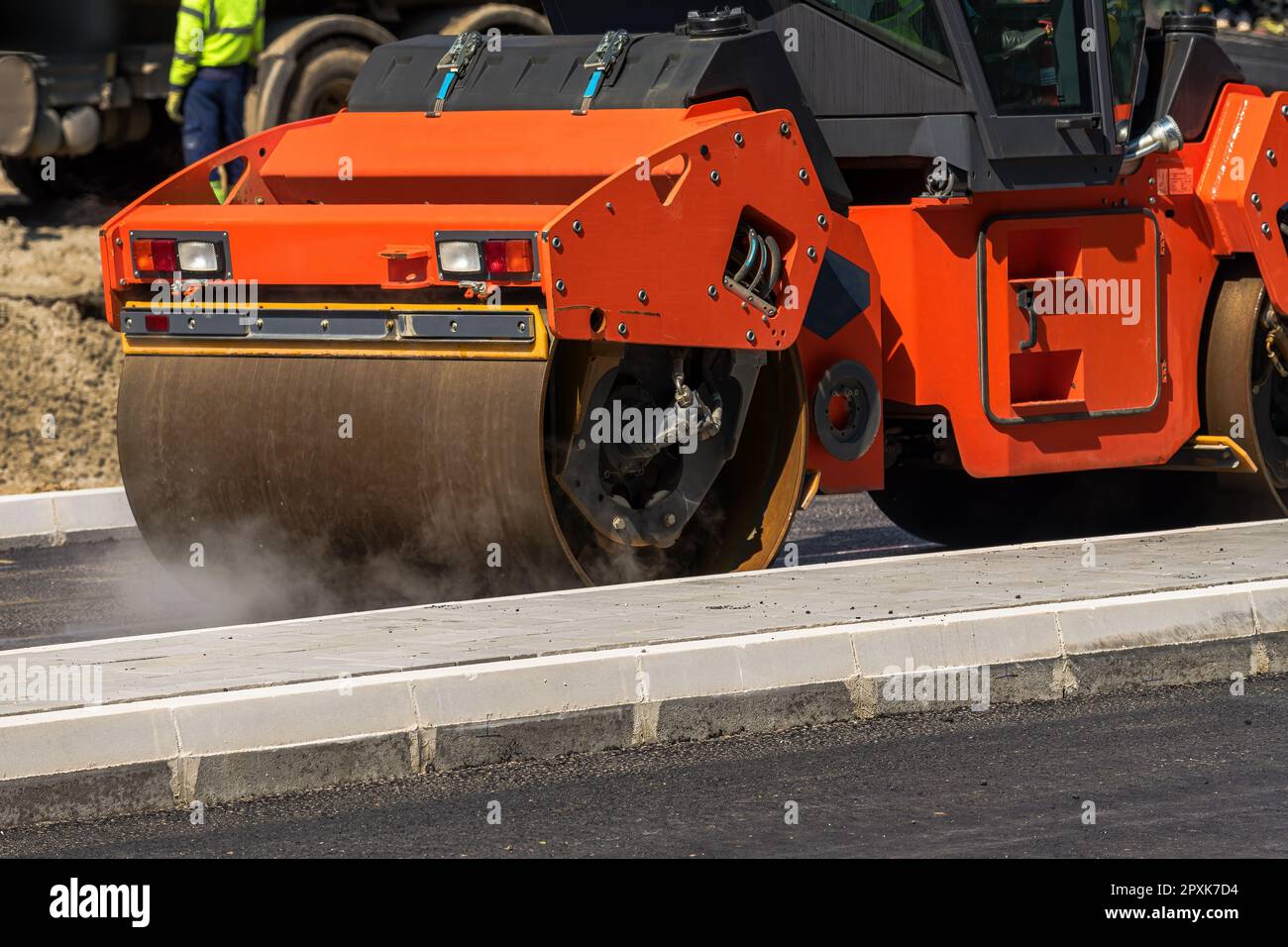Road roller machine working on asphalt road maintenance project ...