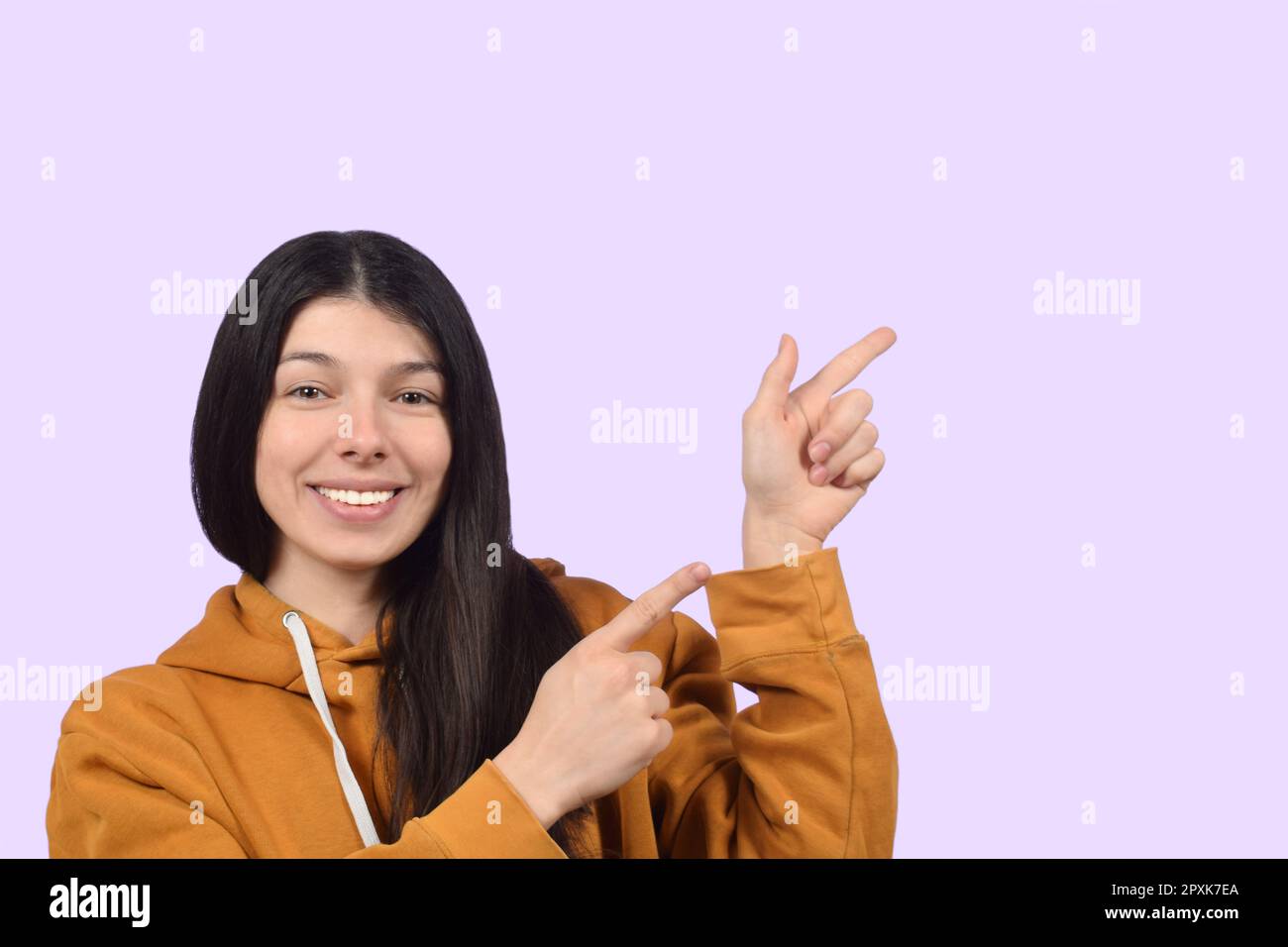 young pretty woman pointing direction with finger Stock Photo - Alamy