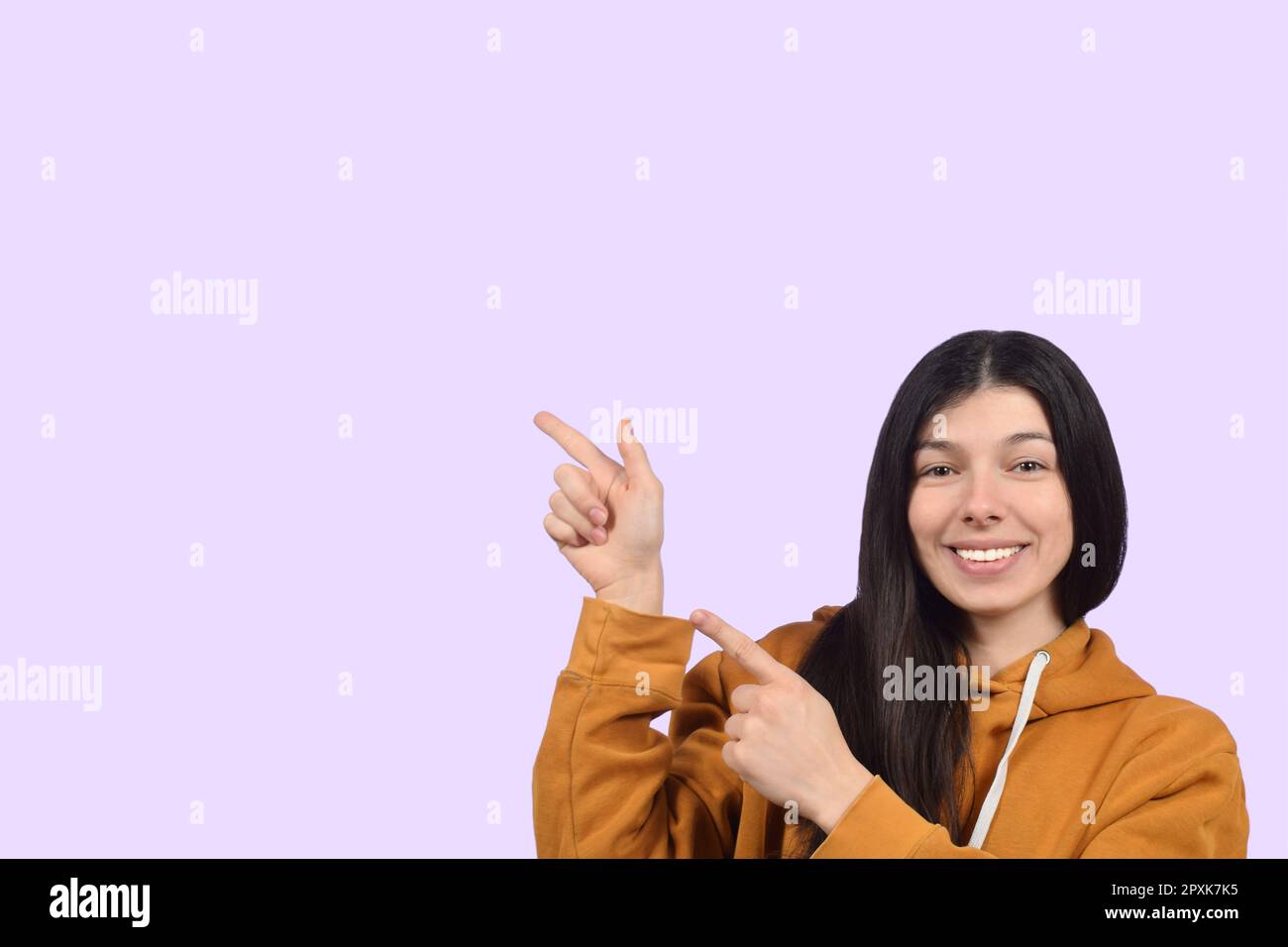 young pretty woman pointing direction with finger Stock Photo - Alamy