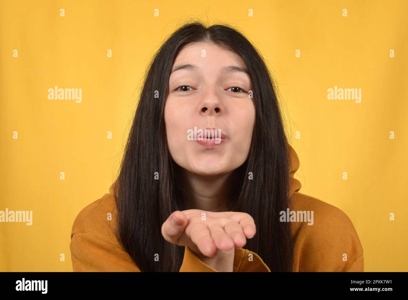 cute pretty brunette woman makes an air kiss Stock Photo - Alamy