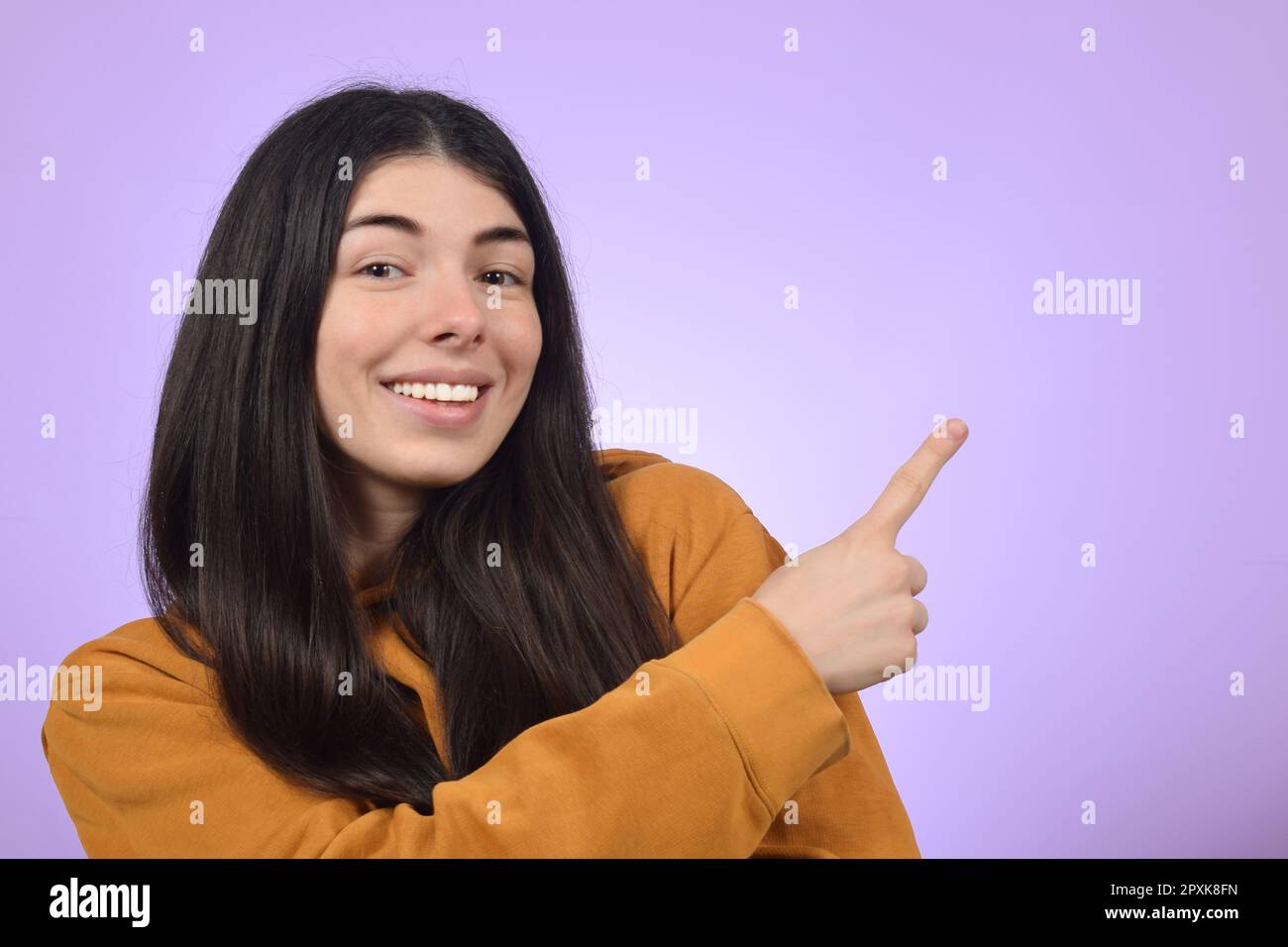 young pretty woman pointing direction with finger Stock Photo - Alamy