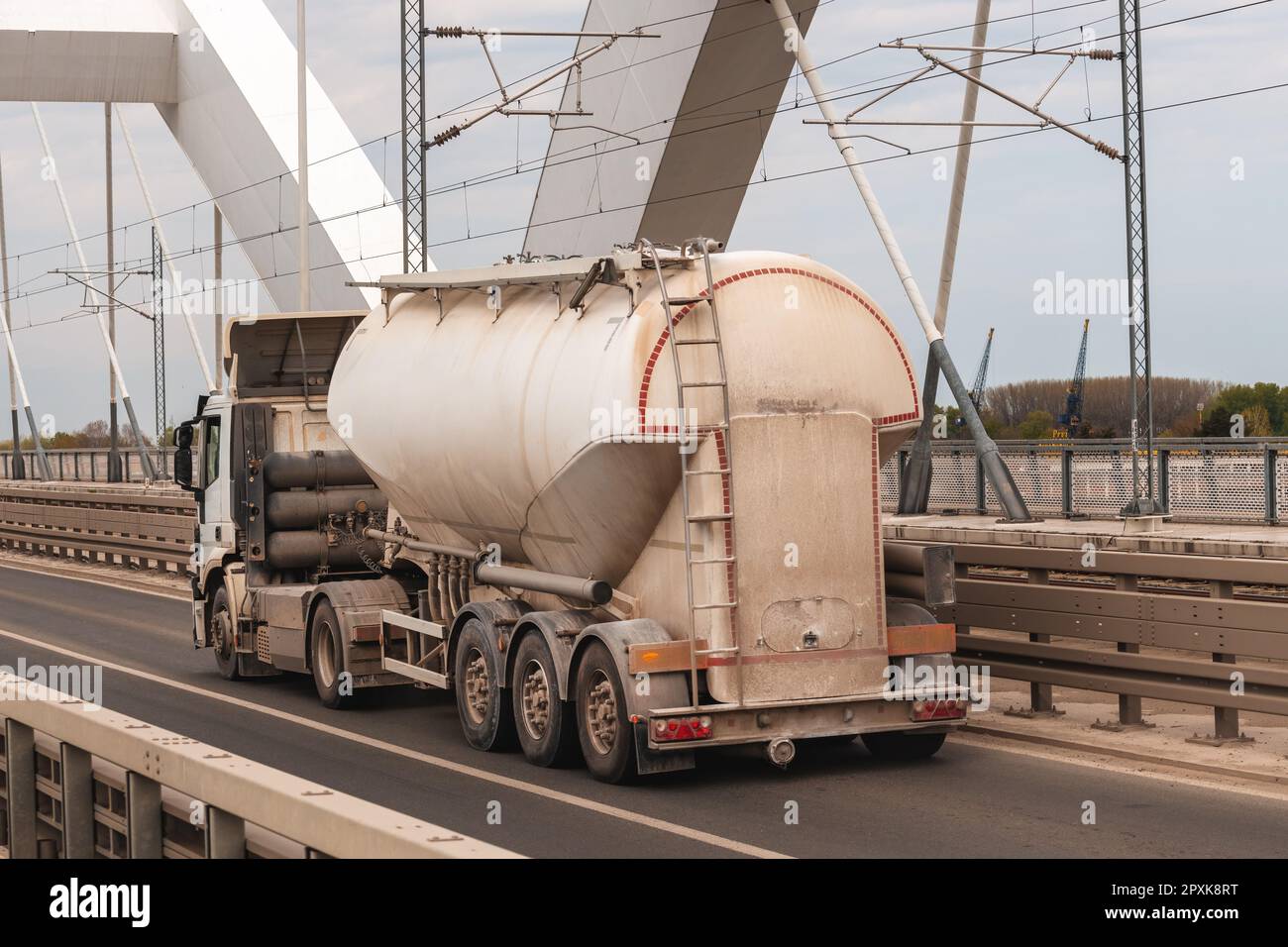 Dirty cistern tank truck is crossing the bridge, industry and ...