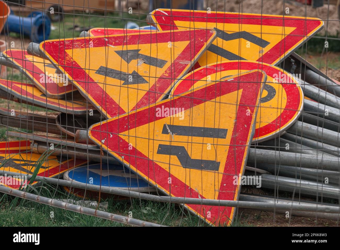 Pile of various traffic signs on road maintenance construction site ...