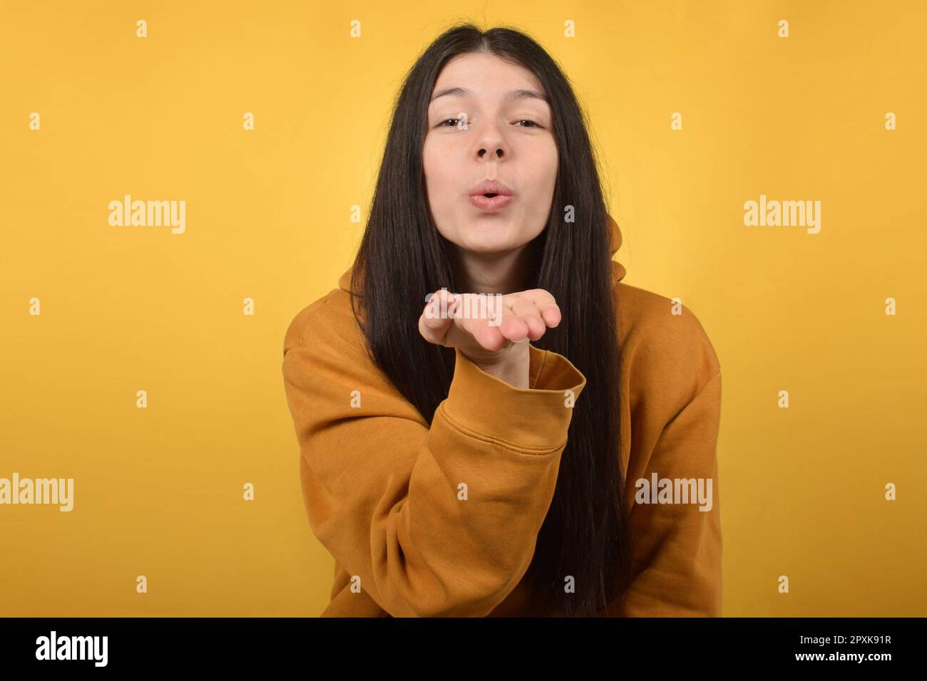 cute pretty brunette woman makes an air kiss Stock Photo - Alamy