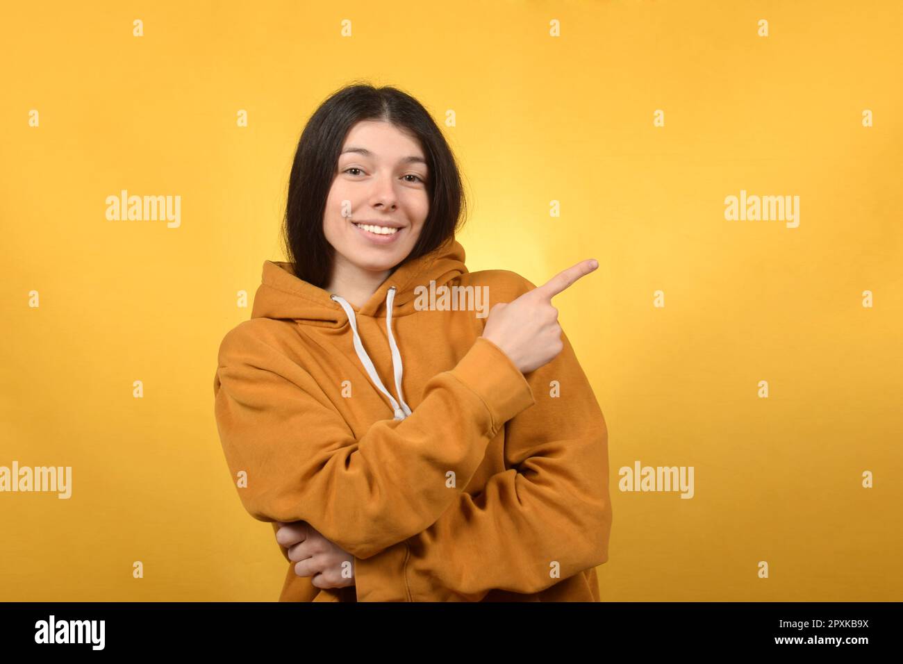 young pretty woman pointing direction with finger Stock Photo - Alamy