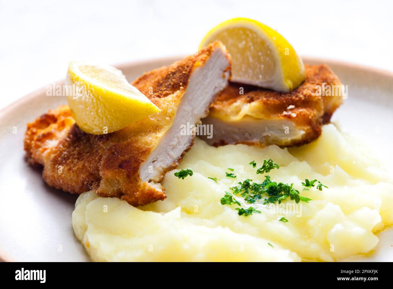 chicken schnitzel with mashed potatoes and lemon Stock Photo - Alamy