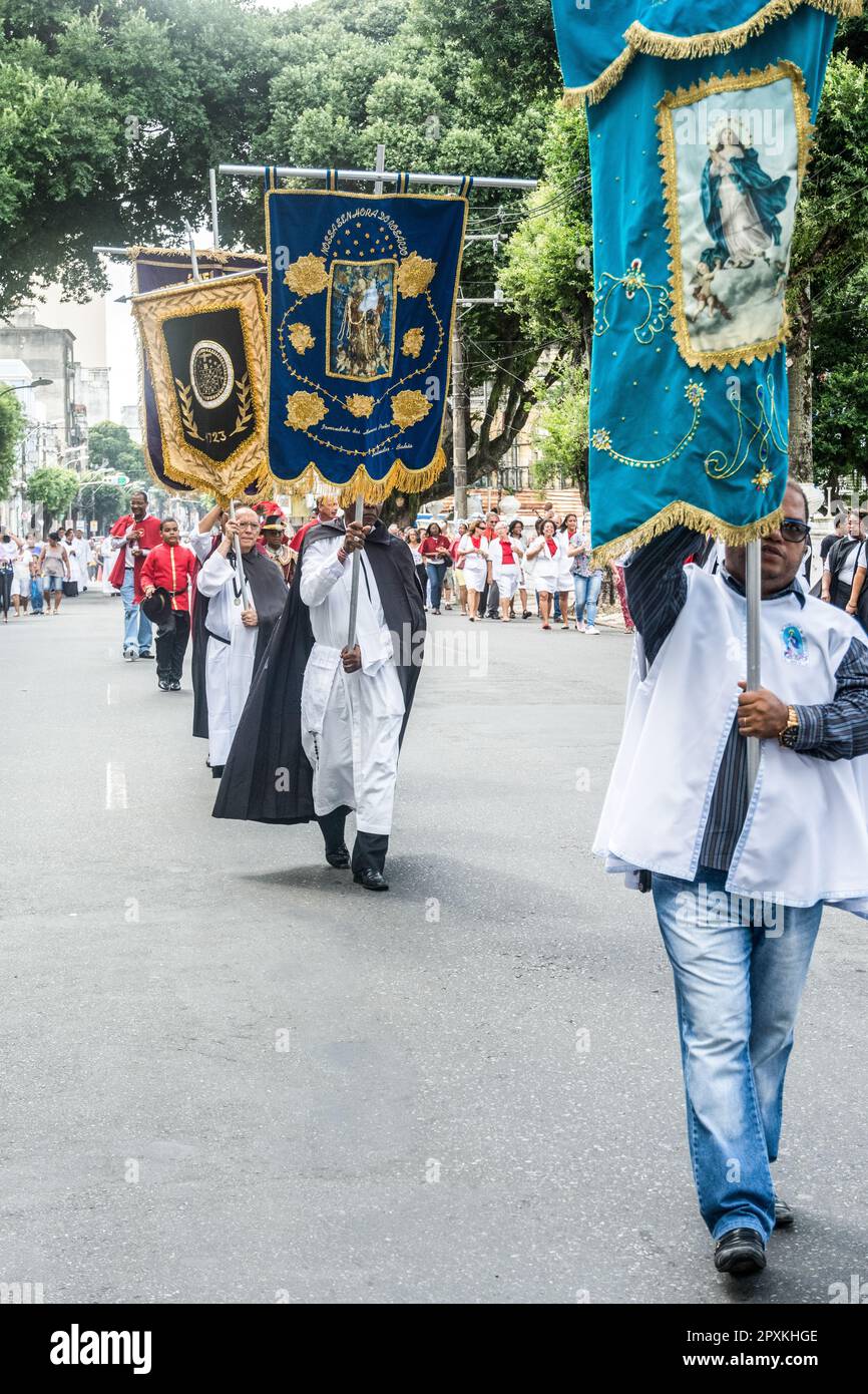 Catholic members hold flags, in line, during the Corpus Christ ...
