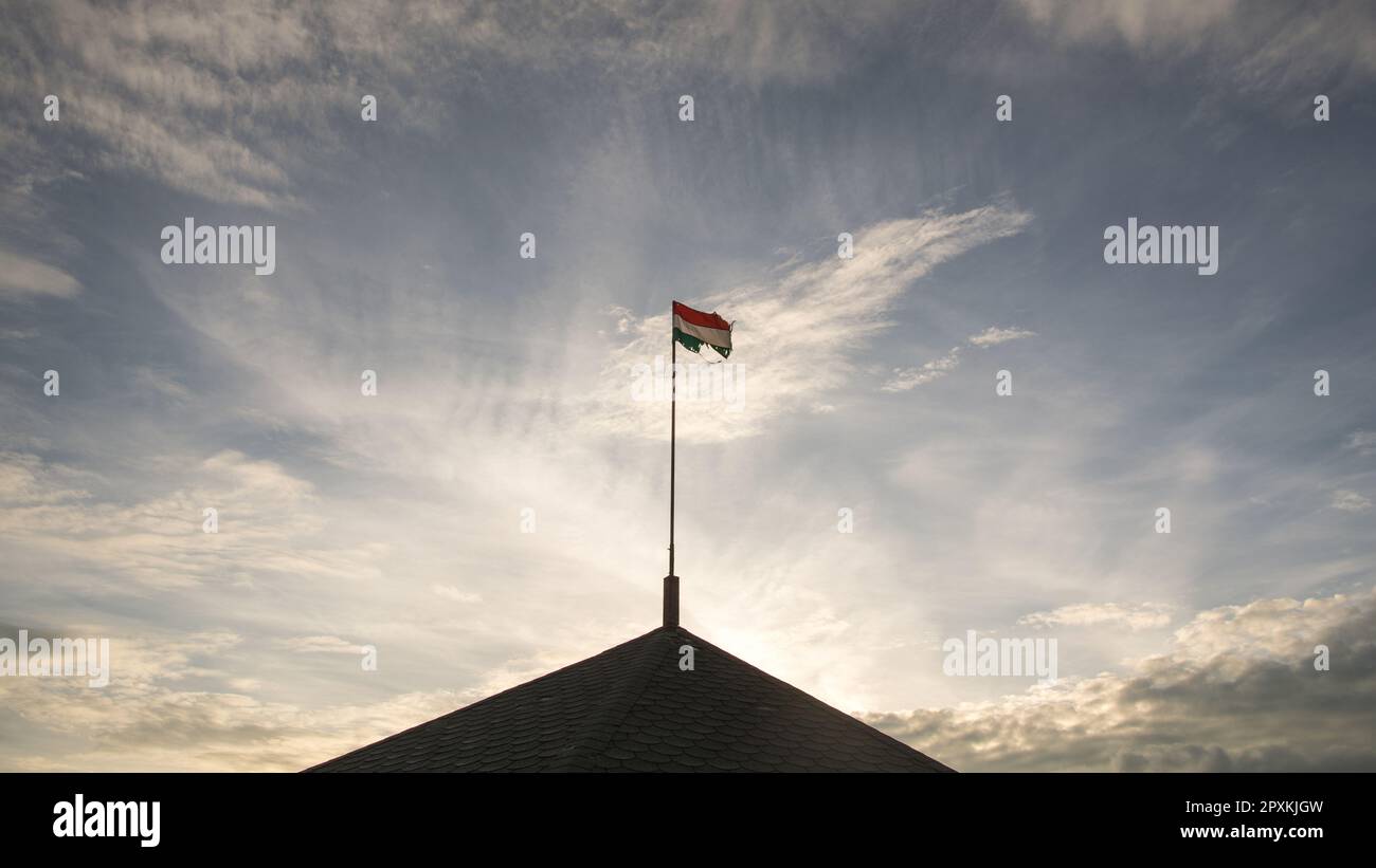 waving torn Hungarian flag in the sky Stock Photo - Alamy