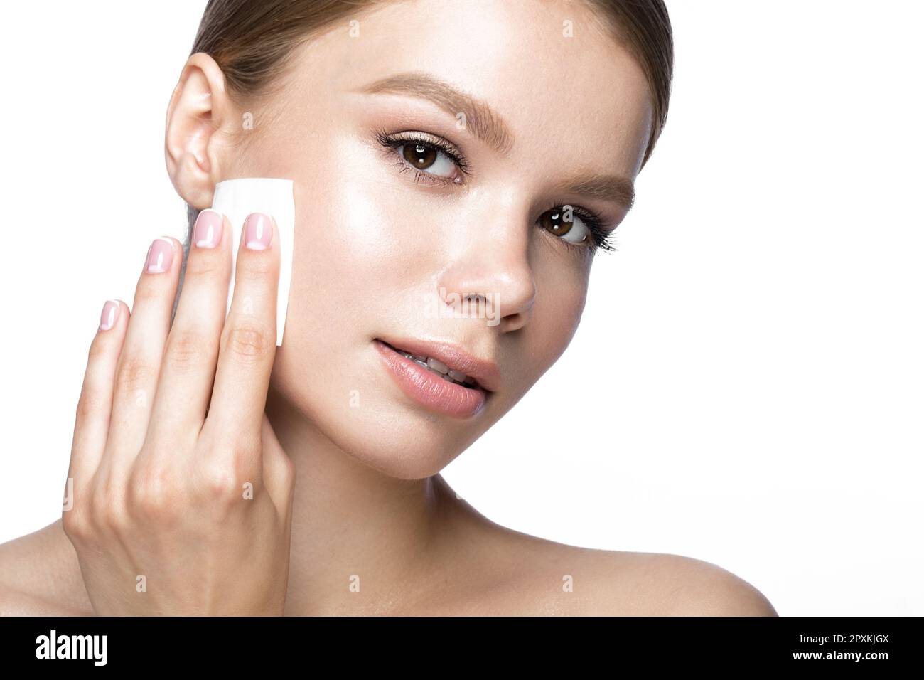 Beautiful young girl with wipes for removing makeup and French manicure ...