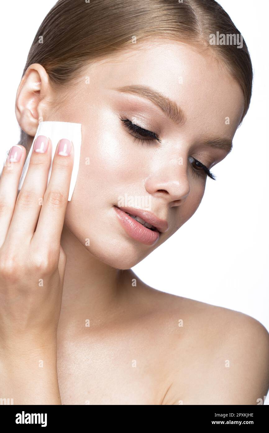 Beautiful young girl with wipes for removing makeup and French manicure ...