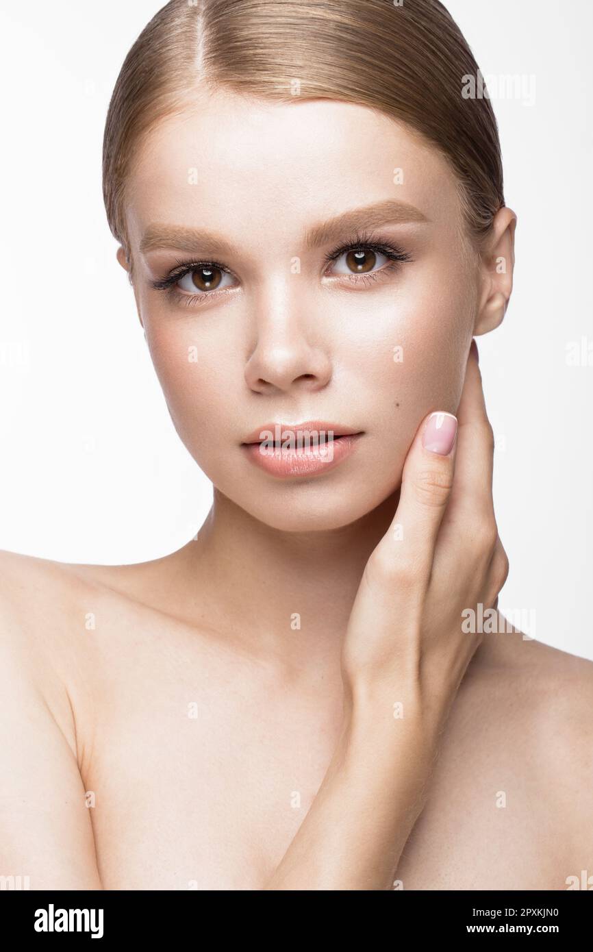 Beautiful young girl with a light natural make-up and French manicure ...