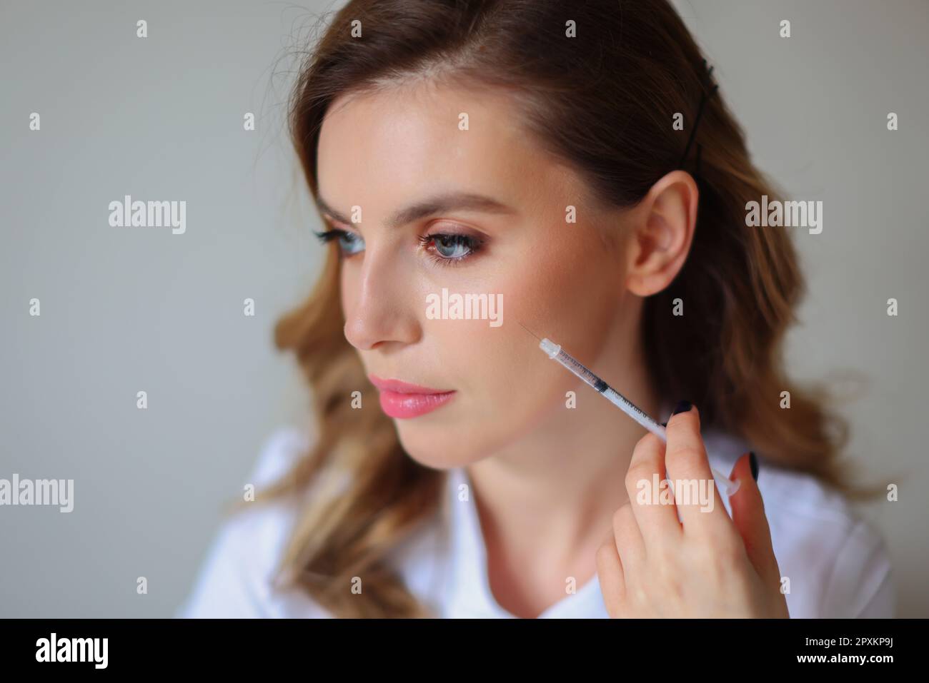 Injection of beauty, cosmetician's hands with a syringe, soft woman's ...