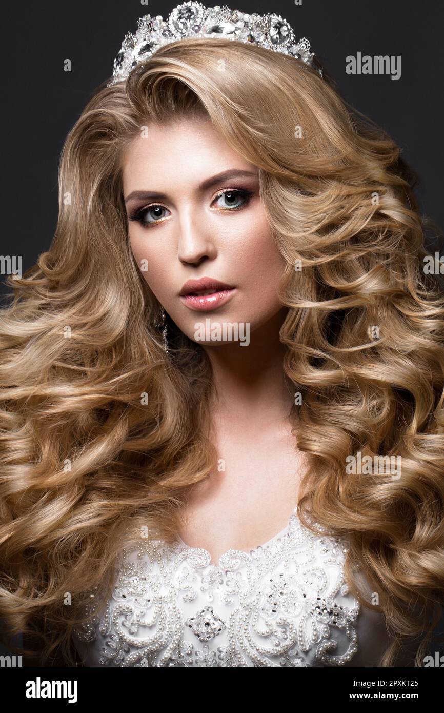 Beautiful blonde bride in wedding image with curls and crown. Beauty ...