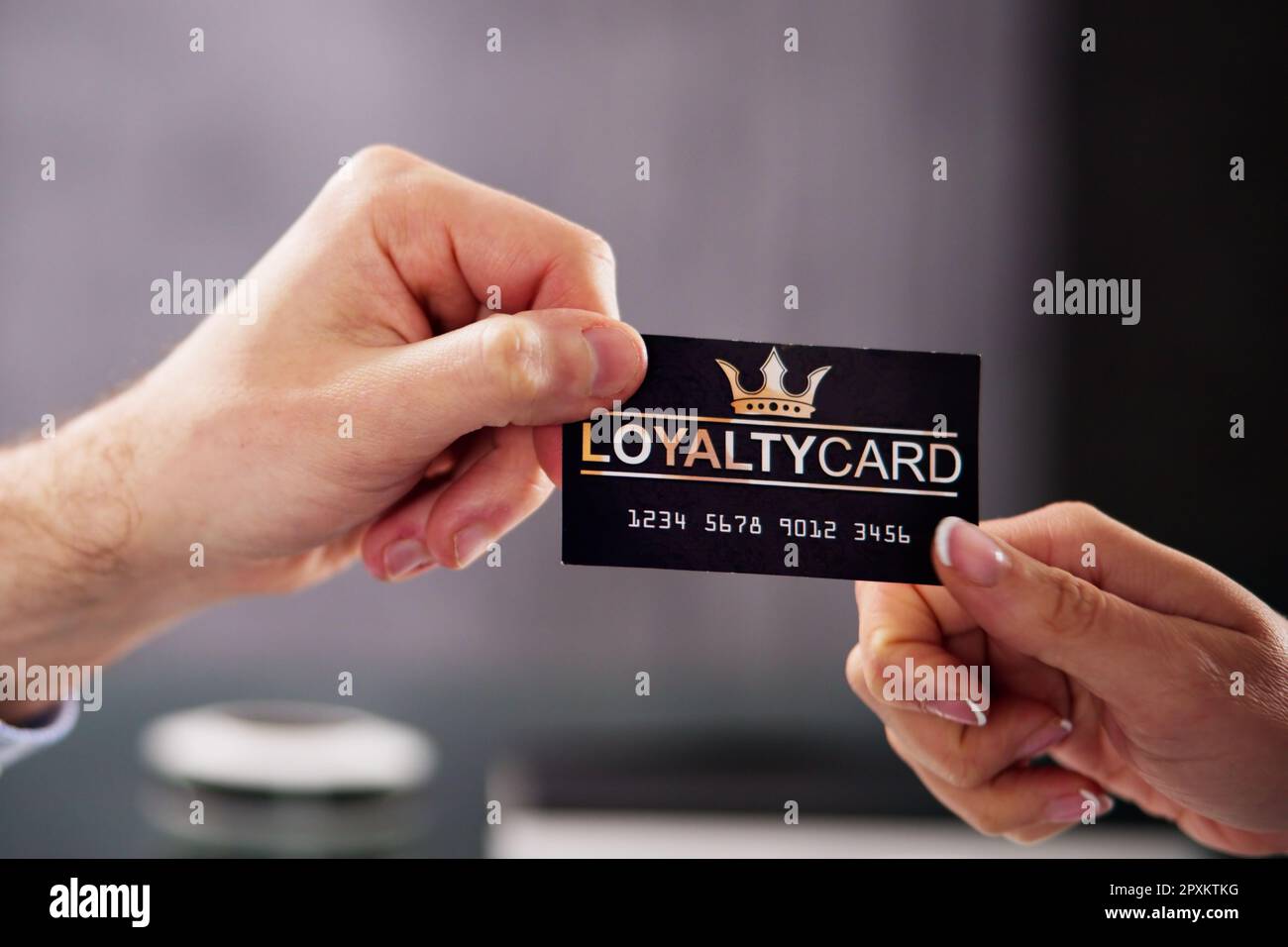 Businessman's Hand Giving Loyalty Card To His Partner Stock Photo - Alamy