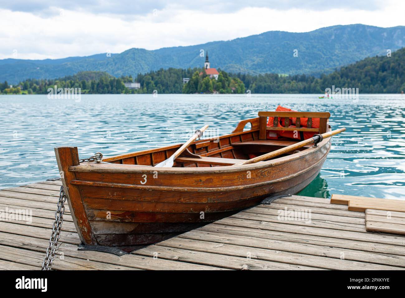wooden rowing boat at the pier of lake bled slovenia Stock Photo - Alamy