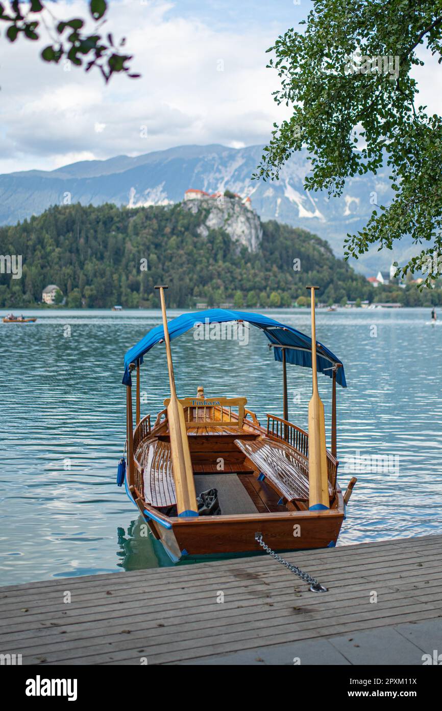 wooden rowing boat moored at the pier of lake bled slovenia Stock Photo ...