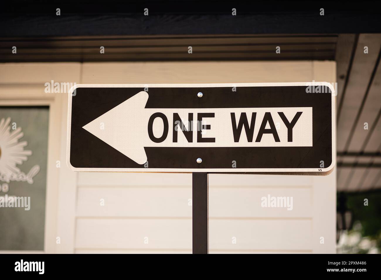 One Way metal sign with black wording on a white arrow at an outdoor ...