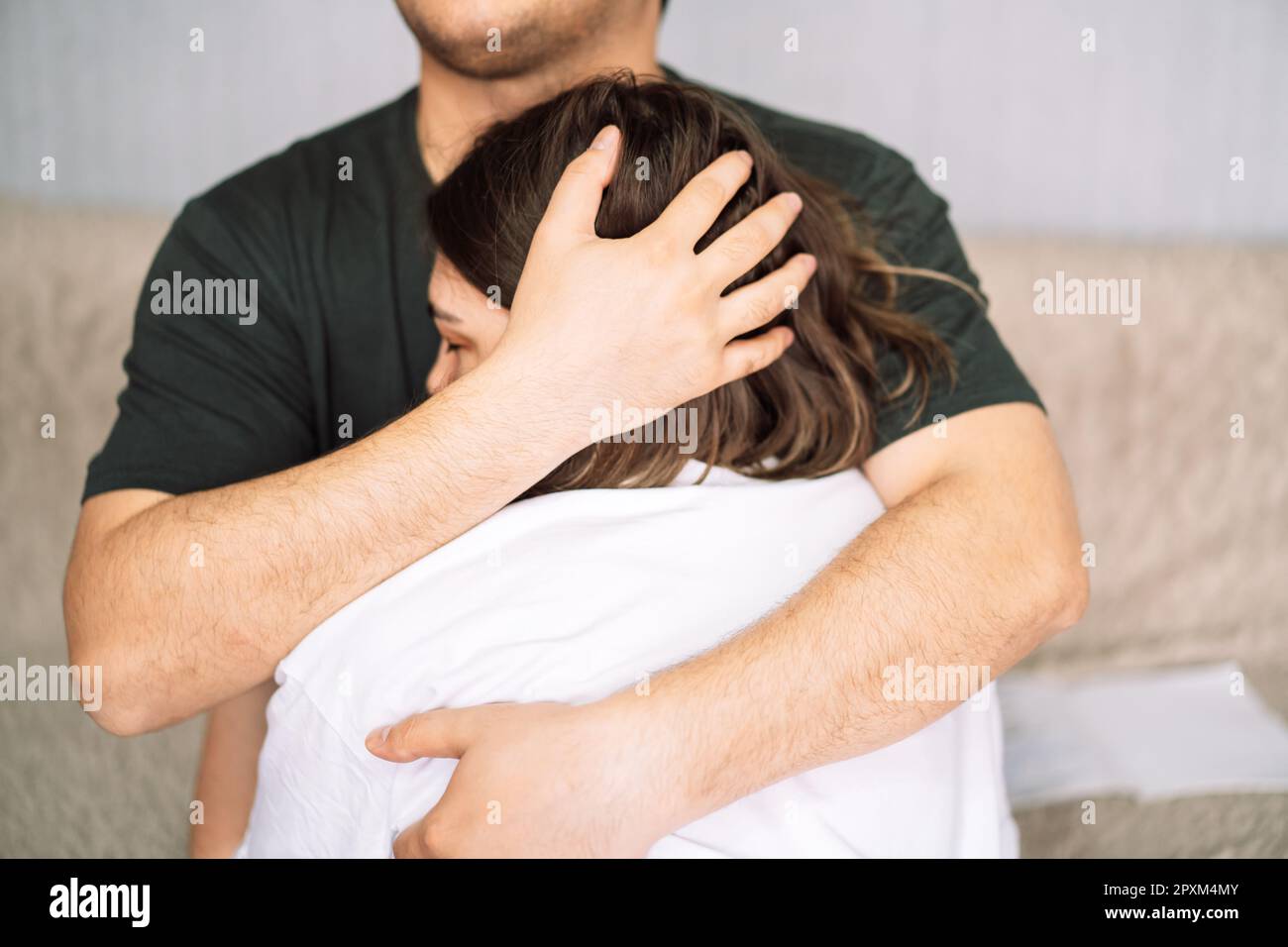 Husband comforts his beloved wife by holding her close Stock Photo - Alamy